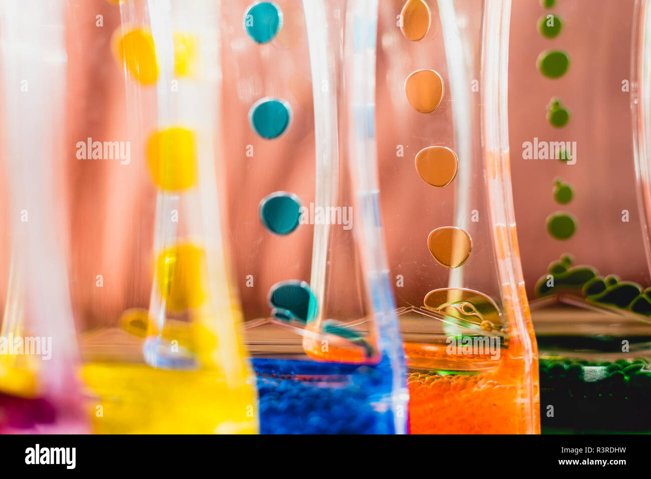 Toy with water and drops of oil colors Stock Photo - Alamy