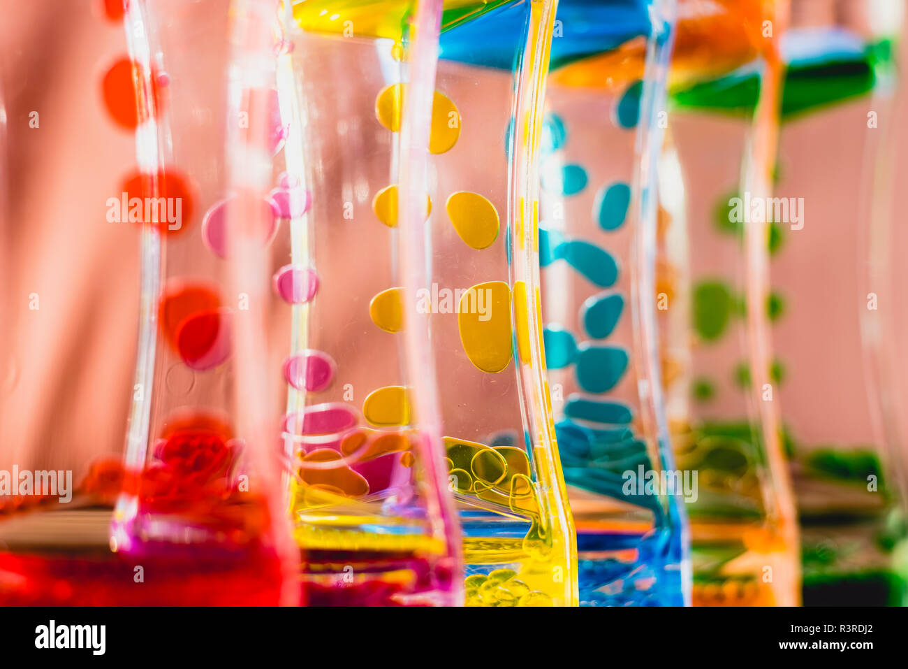 Toy with water and drops of oil colors Stock Photo - Alamy