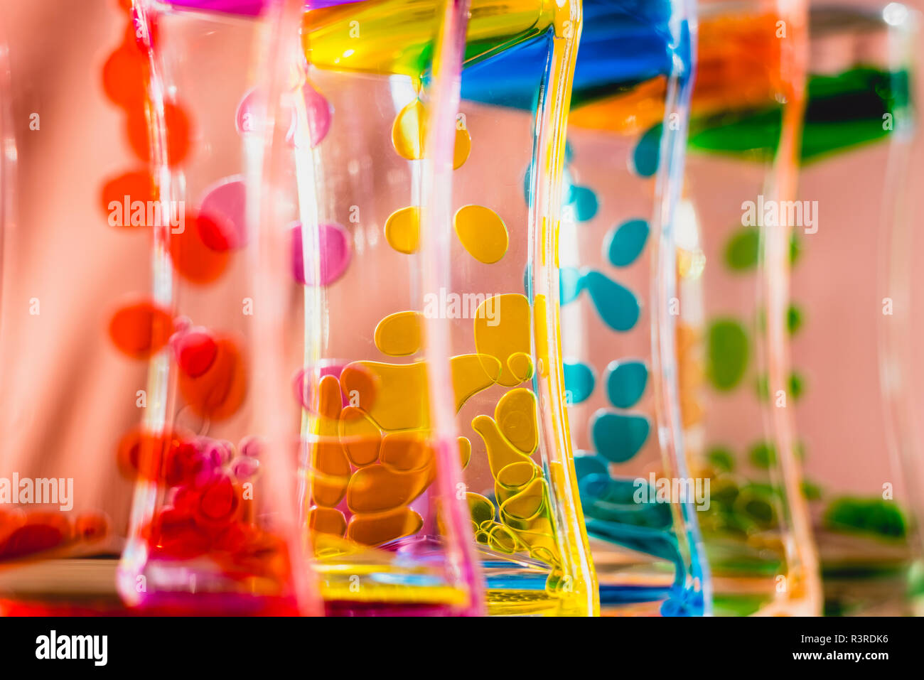 Toy with water and drops of oil colors Stock Photo - Alamy