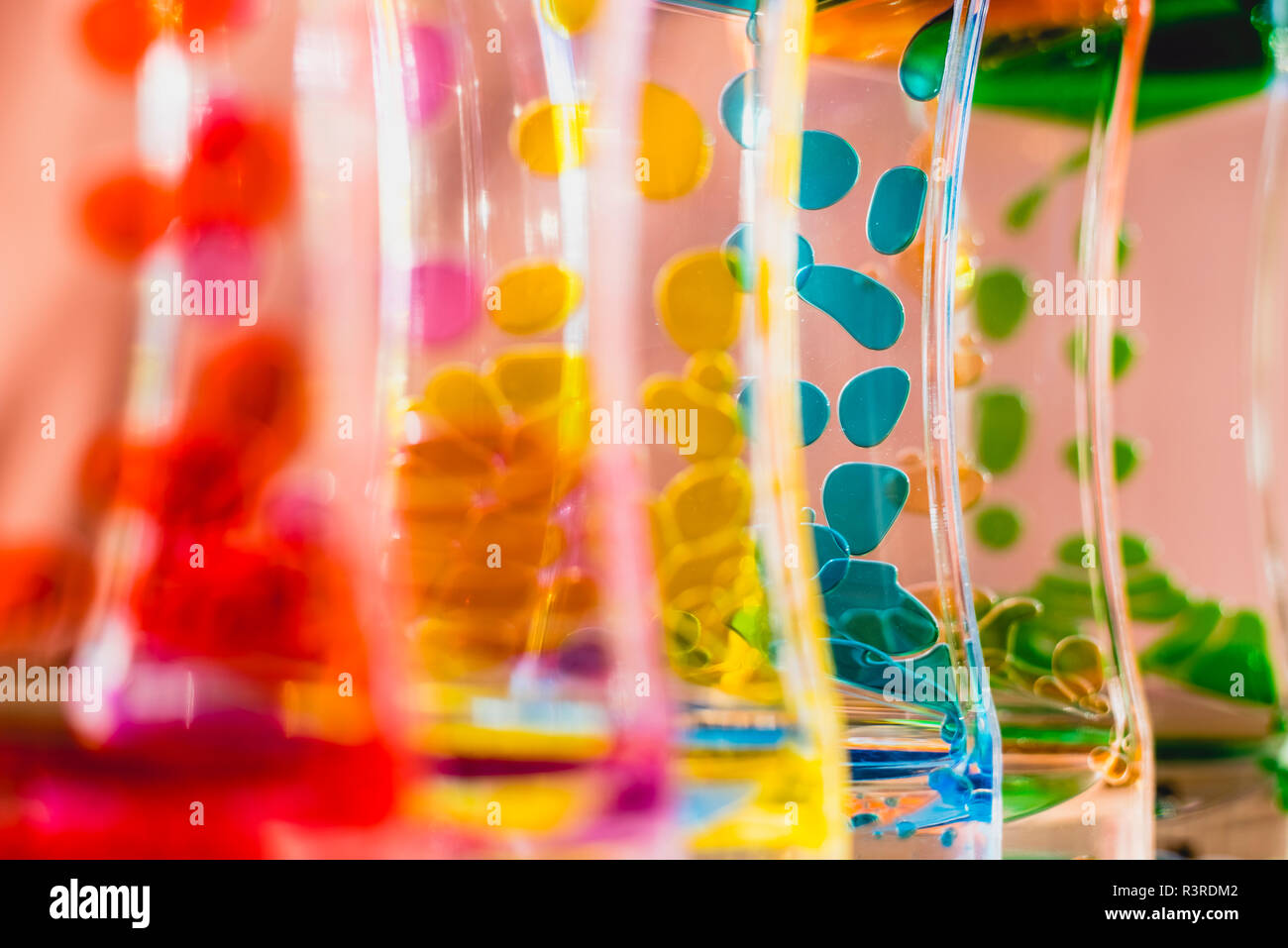 Toy with water and drops of oil colors Stock Photo - Alamy