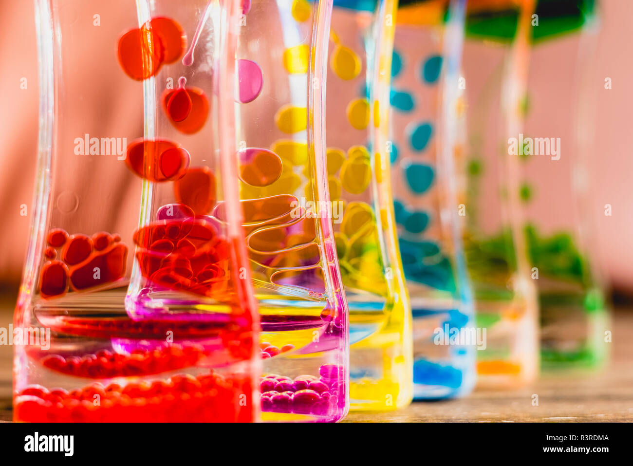 Toy with water and drops of oil colors Stock Photo - Alamy