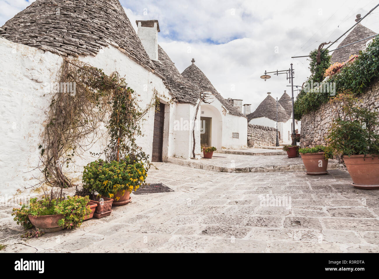 Italy, Apulia, Alberobello, view to alley with typically Trulli Stock ...
