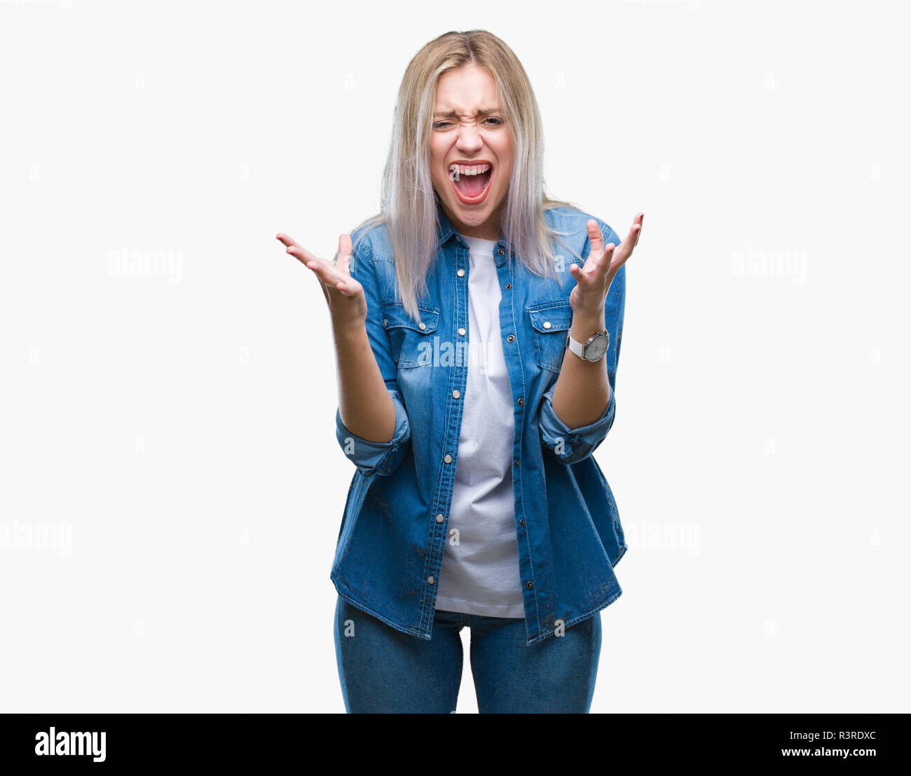 Young blonde woman over isolated background crazy and mad shouting and ...