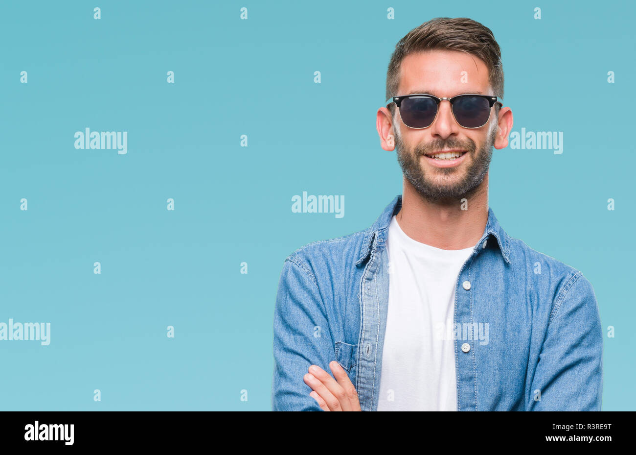 Young handsome man wearing sunglasses over isolated background happy ...