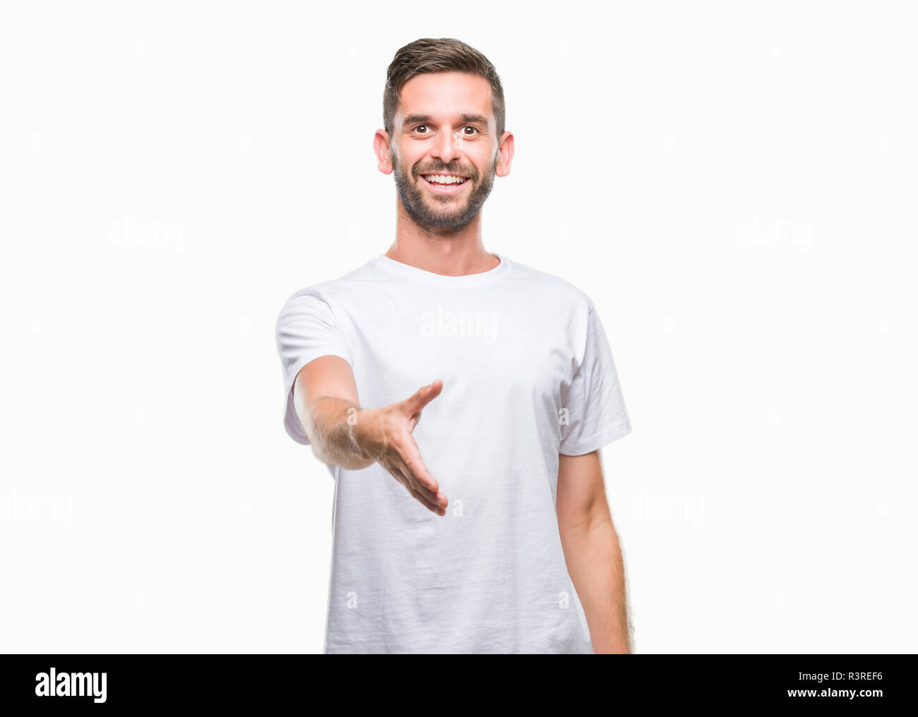 Young handsome man over isolated background smiling friendly offering ...