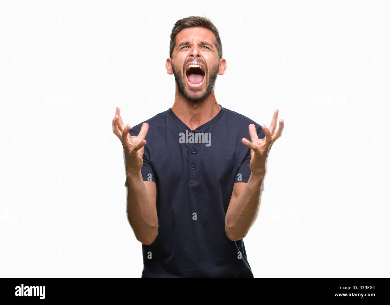 Young handsome man over isolated background crazy and mad shouting and ...