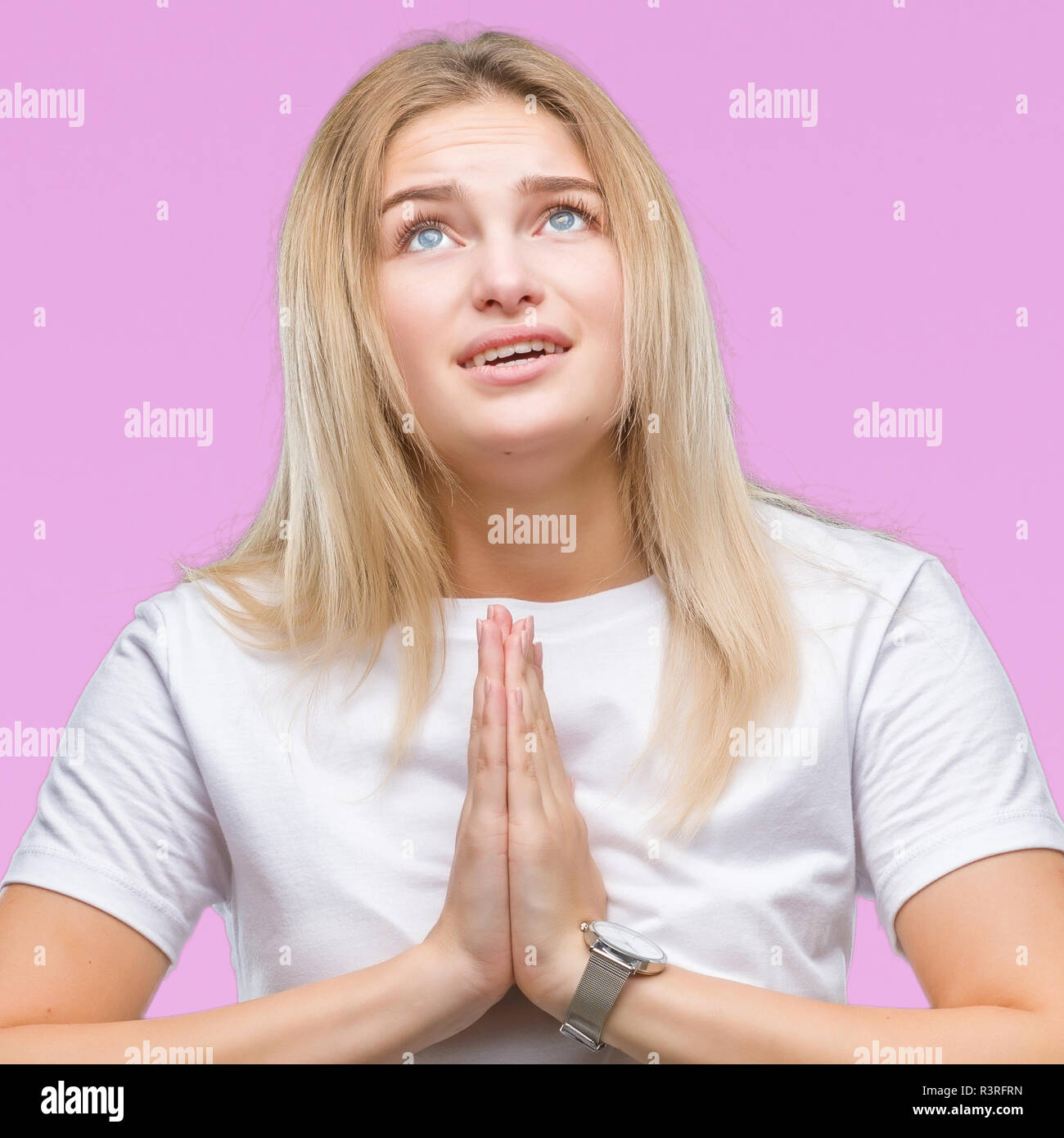 Young caucasian woman over isolated background begging and praying with ...