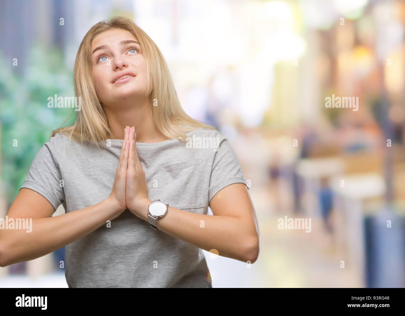 Young caucasian woman over isolated background begging and praying with ...