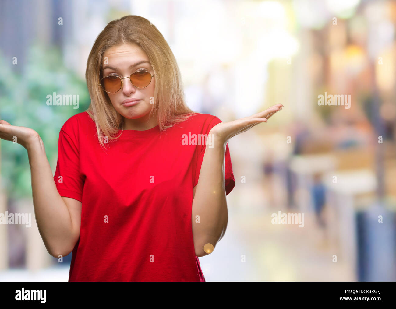 Young caucasian woman wearing sunglasses over isolated background ...