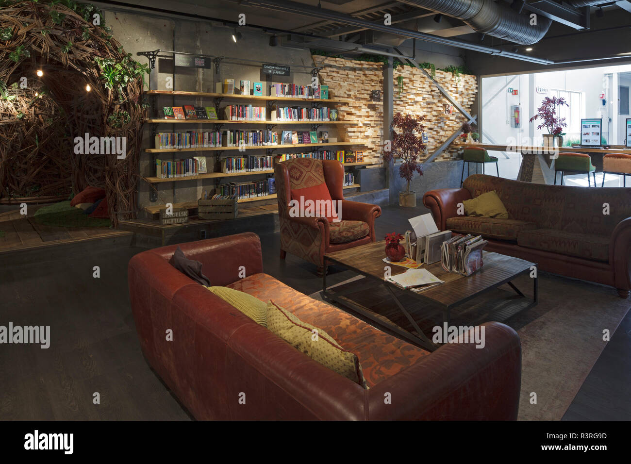 Seating with leather sofas and view to shopping mall beyond. Deichman ...