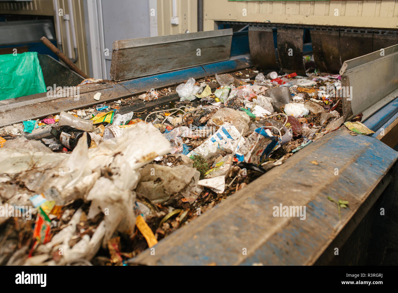 Waste sorting plant. Conveyor on which waste is moving to enter the ...