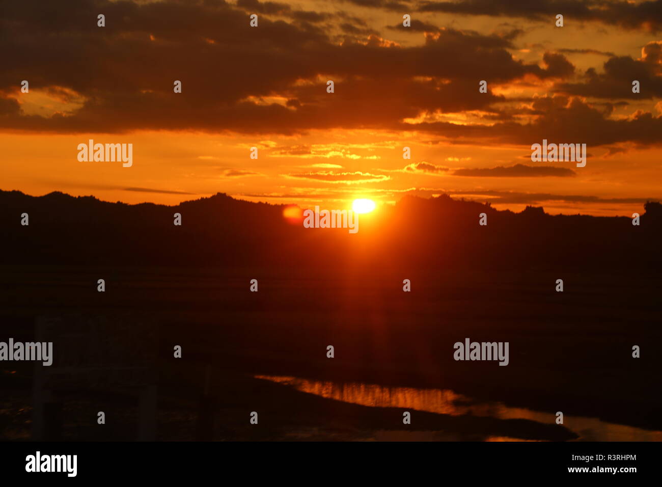Sun rising at sea beach Stock Photo - Alamy
