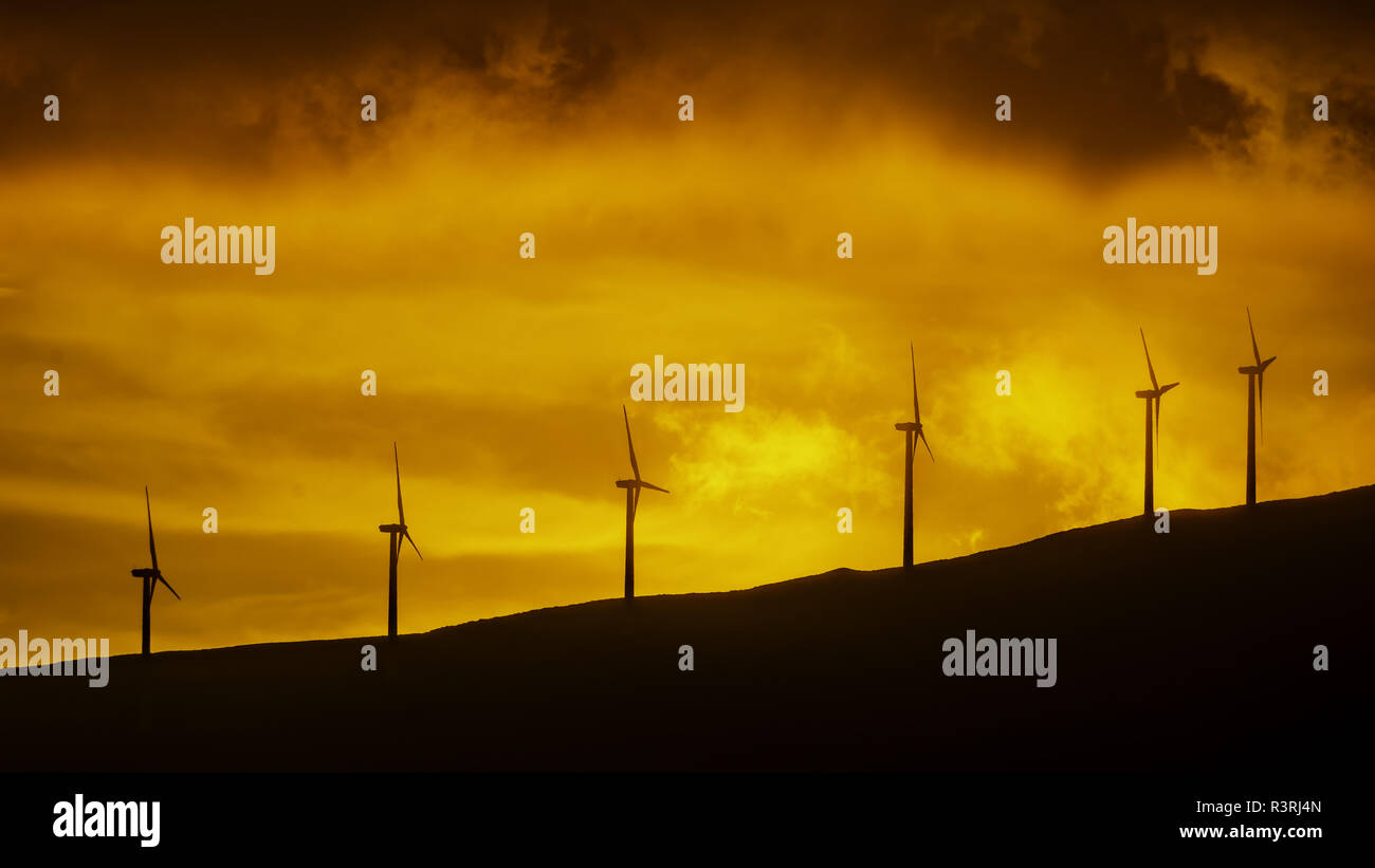 Wind turbines against an orange sunset at Maui Hawaii USA Stock Photo ...