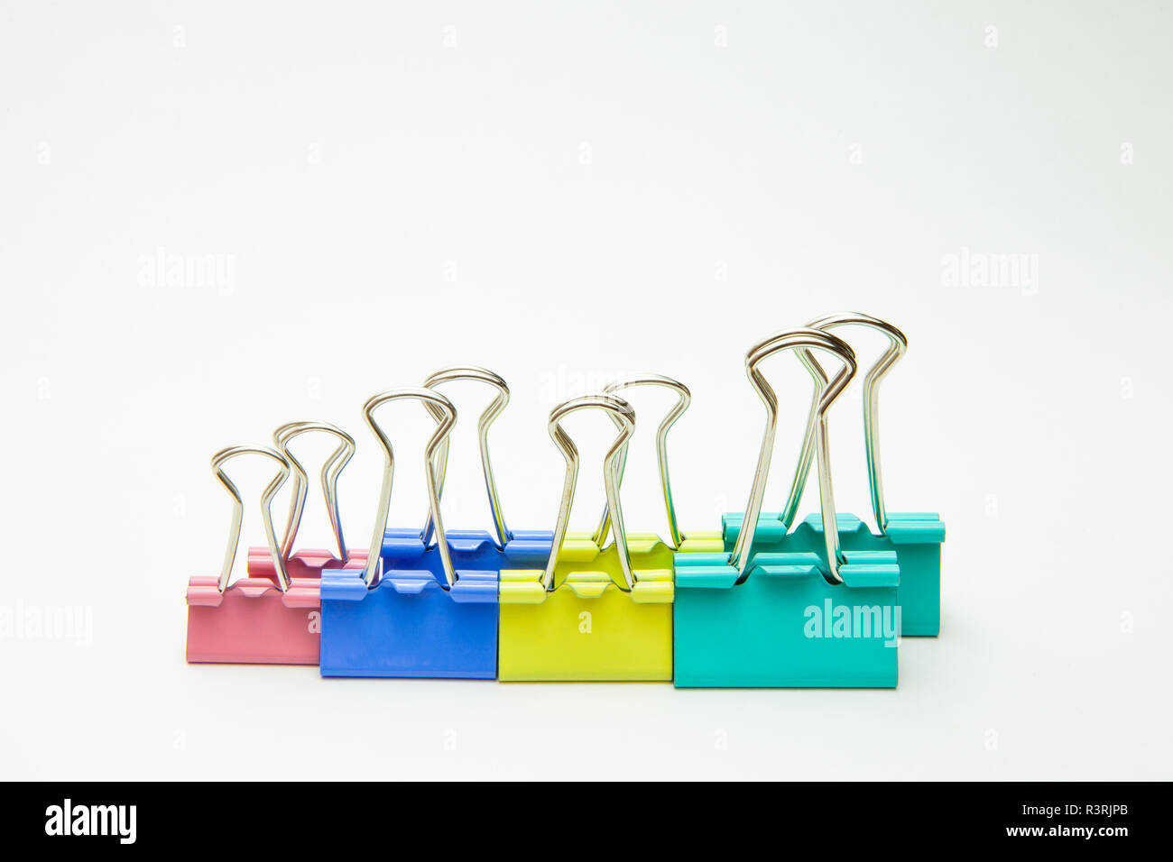 Clips for paper of different colors in a row, close-up on a white ...