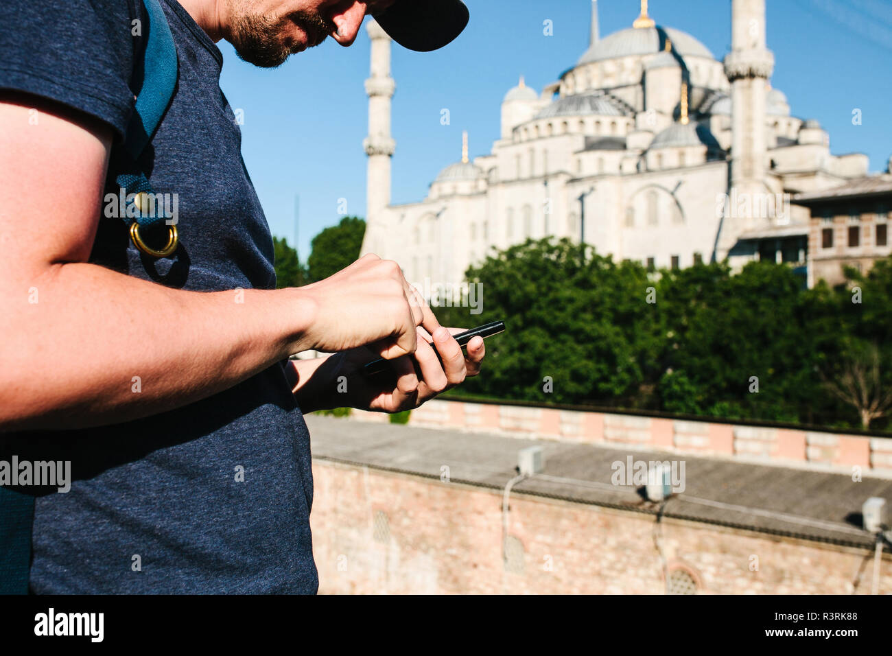 A tourist uses a mobile phone to call or look at a map or write a ...