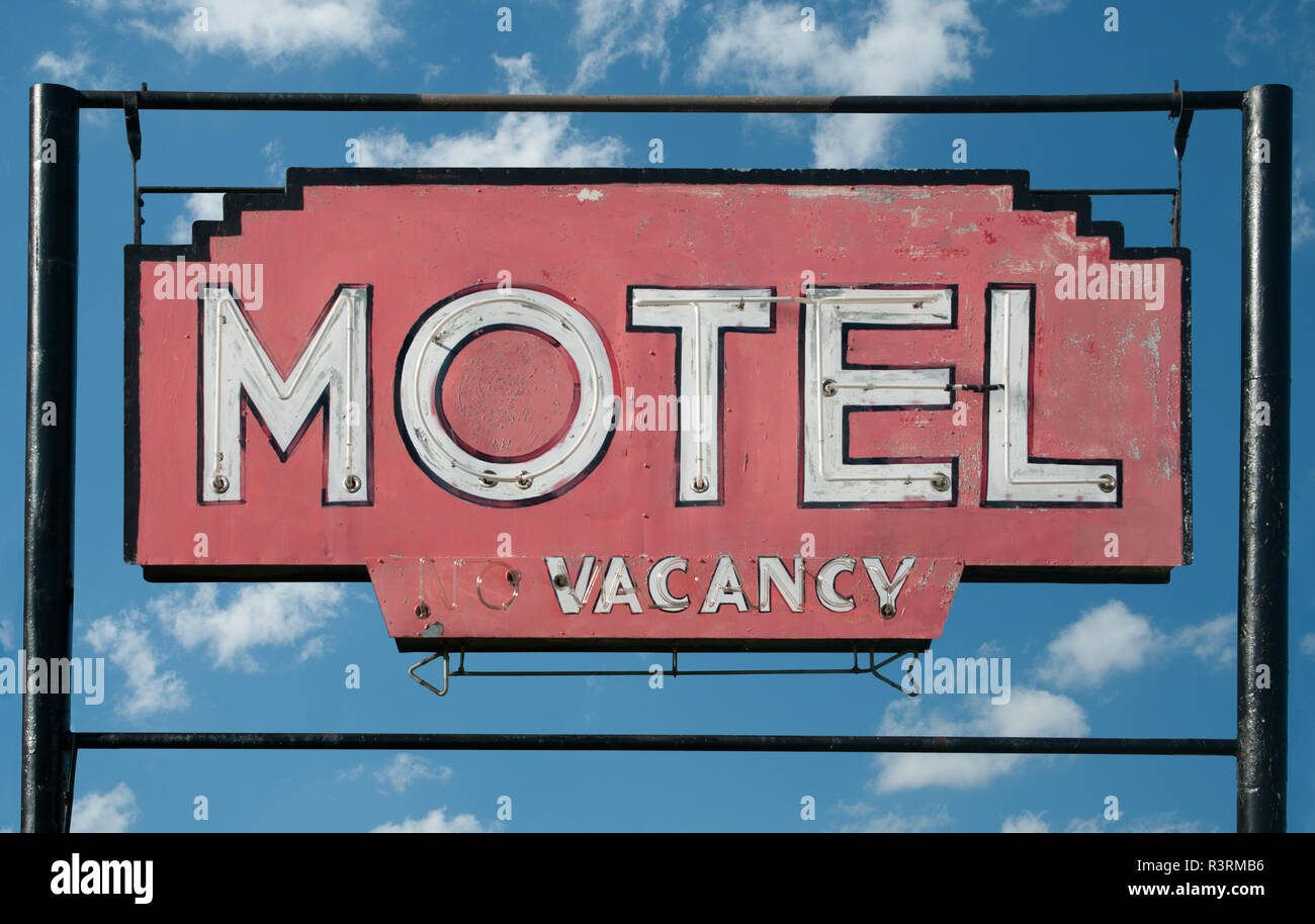 Motel Sign: A weathered sign invites travelers to stop at a small motel ...