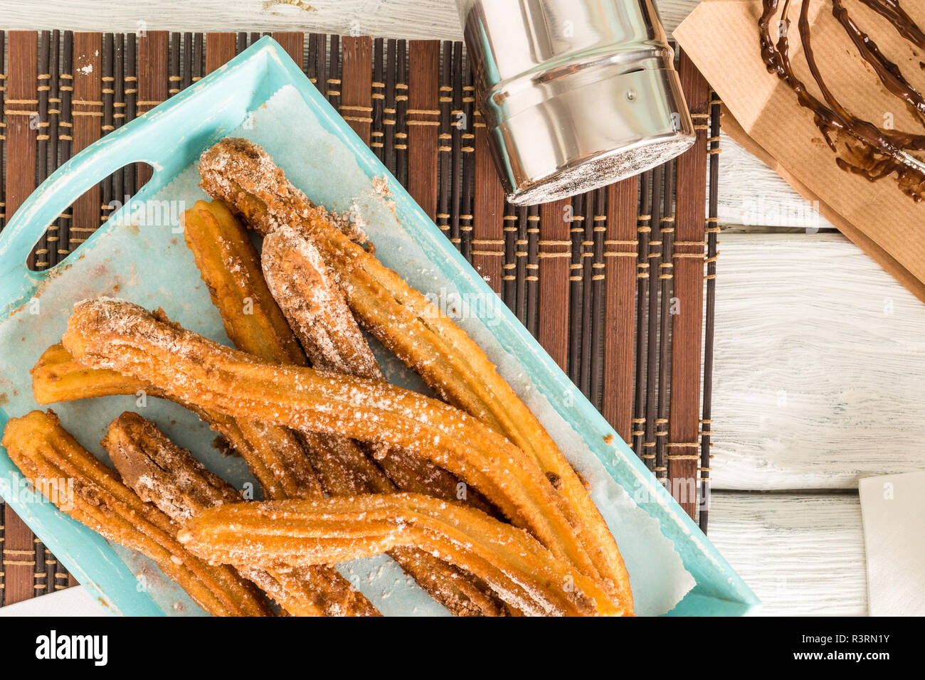 Traditional churros with hot chocolate dipping sauce on wooden counter ...