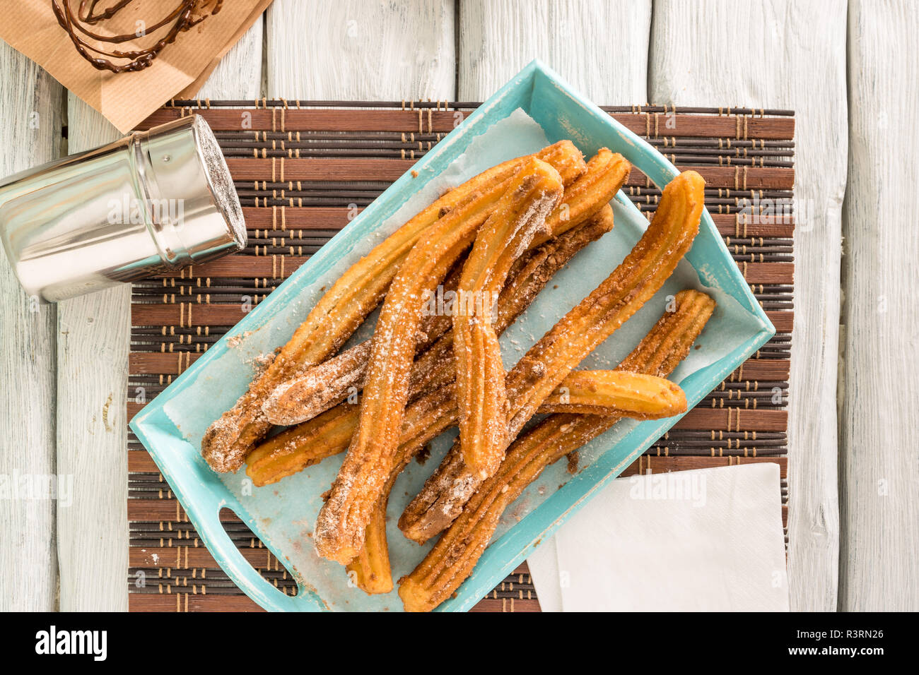 Traditional churros with hot chocolate dipping sauce on wooden counter ...