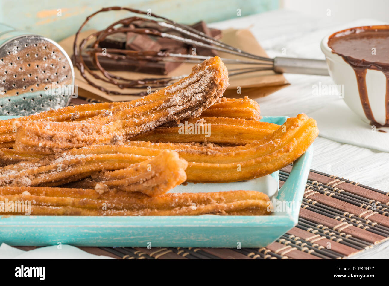 Traditional churros with hot chocolate dipping sauce on wooden counter ...