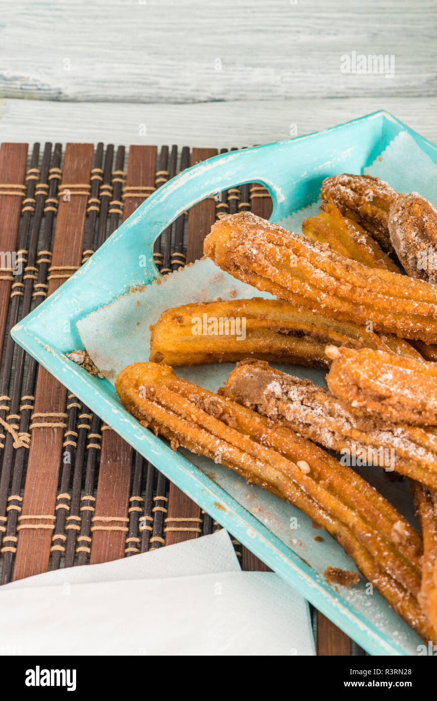 Traditional churros with hot chocolate dipping sauce on wooden counter ...