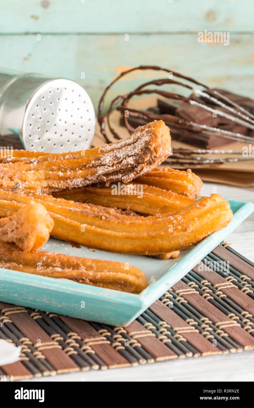 Traditional churros with hot chocolate dipping sauce on wooden counter ...
