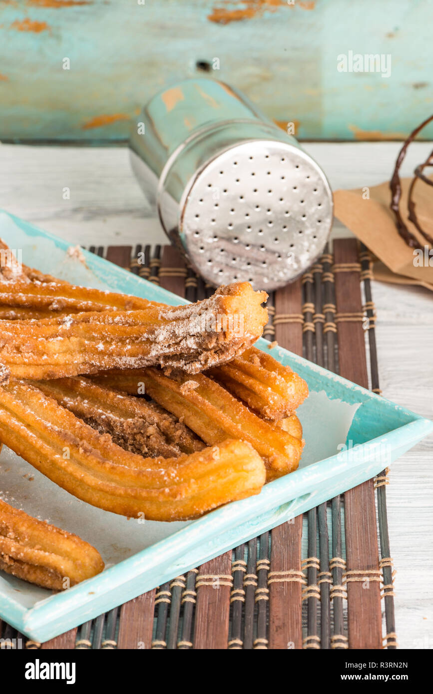 Traditional churros with hot chocolate dipping sauce on wooden counter ...