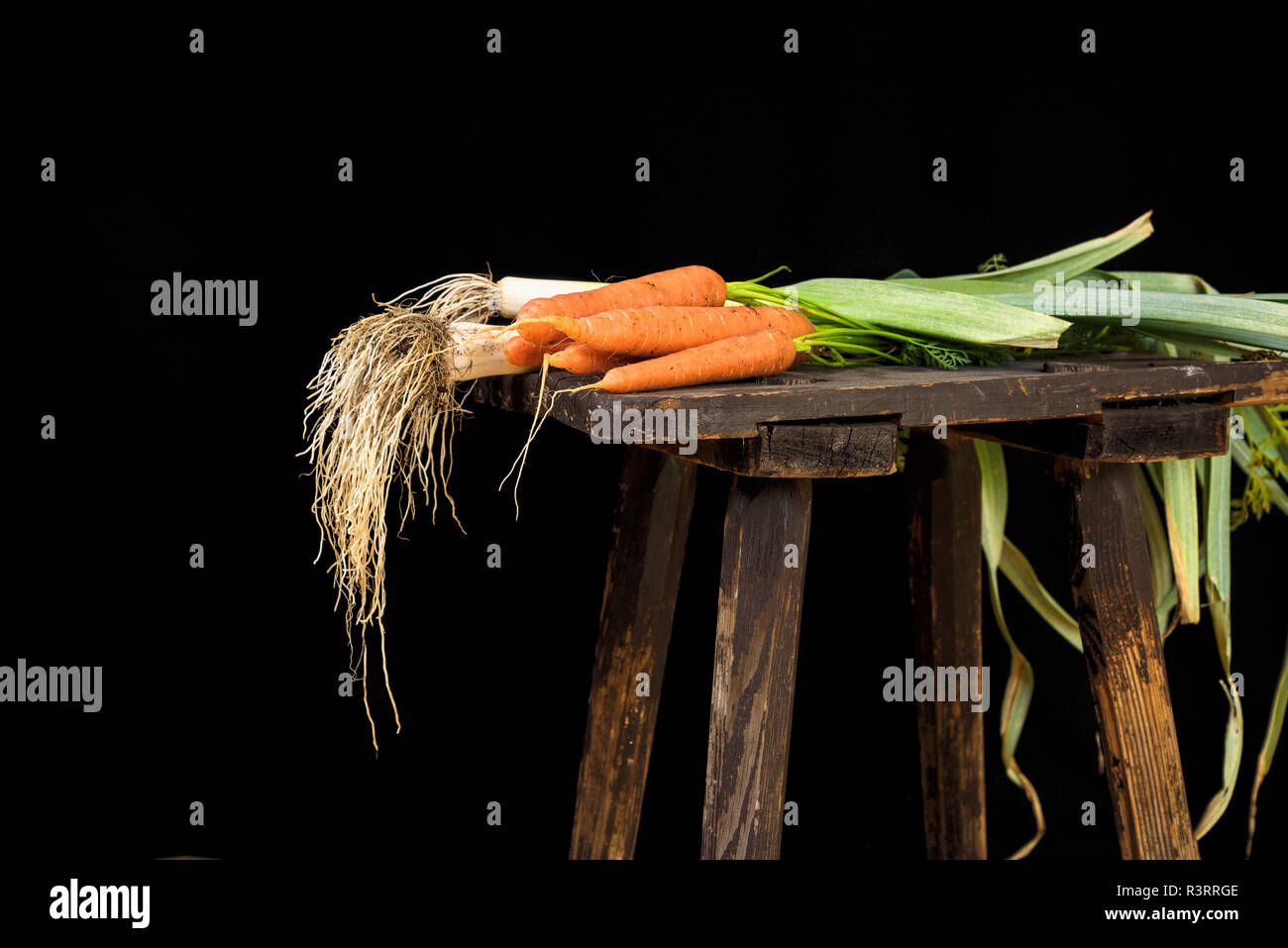 organic carrots and leeks harvested from the vegetable garden on an old ...