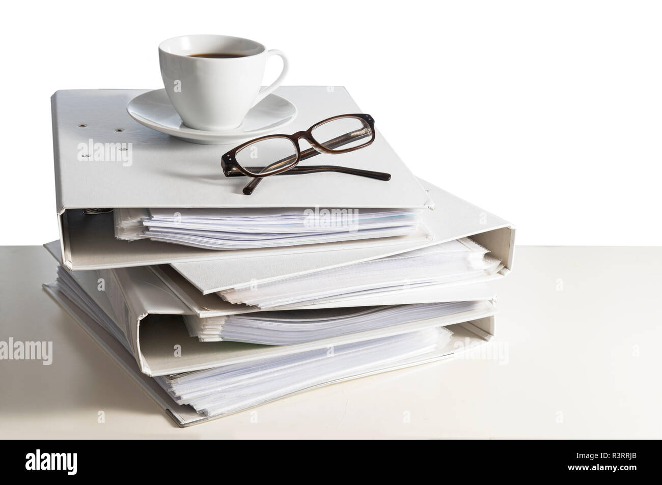 stack of folders, glasses and a cup of coffee on a desk, isolated on a ...