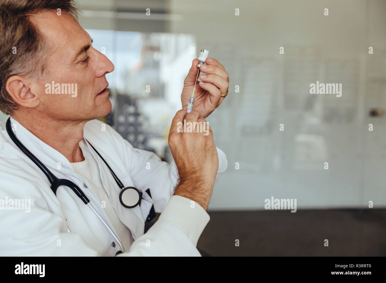 Doctor preparing injection, filling syringe Stock Photo - Alamy