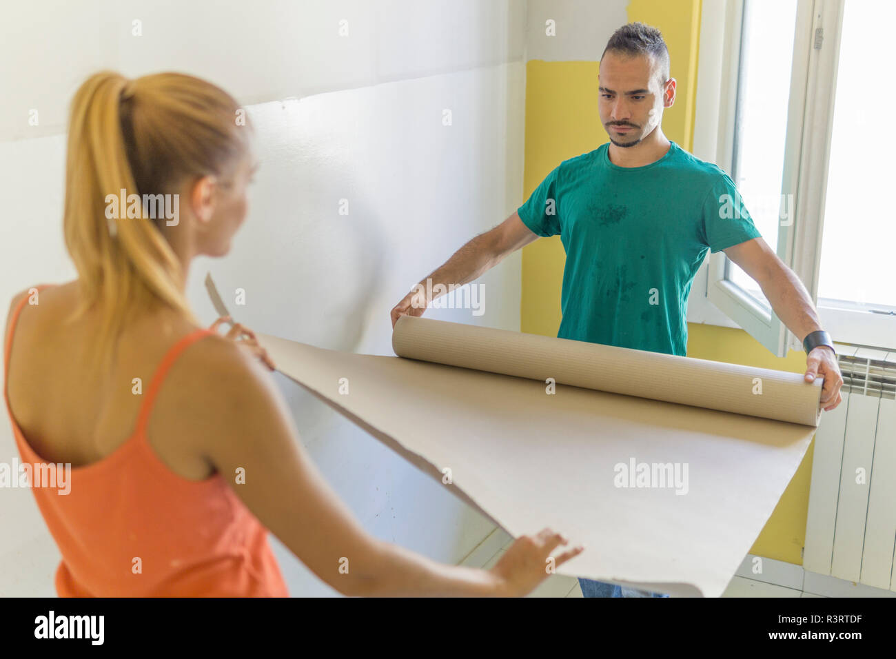 Couple preparing room at new home for renovation Stock Photo - Alamy