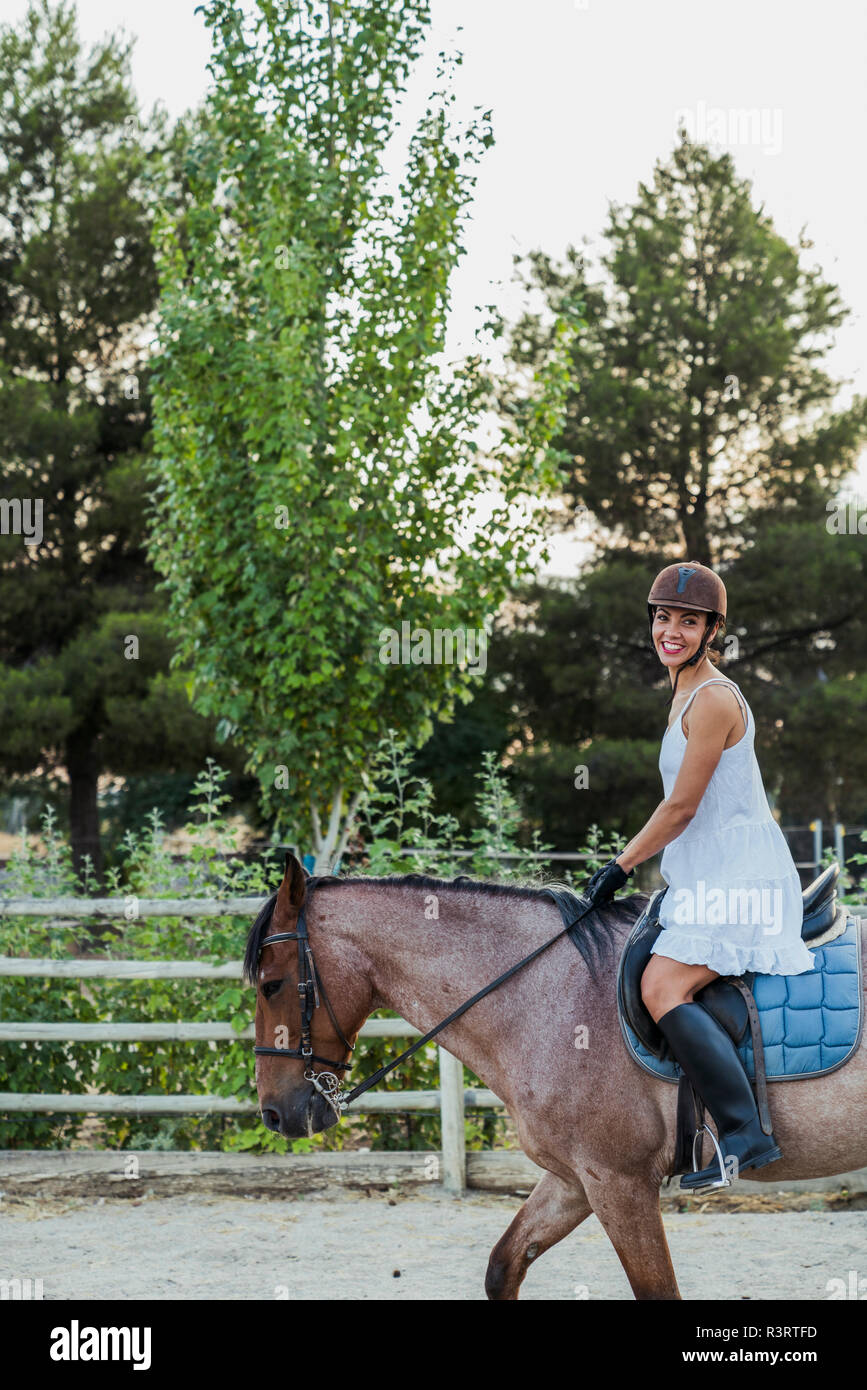 Happy woman riding on horse Stock Photo - Alamy
