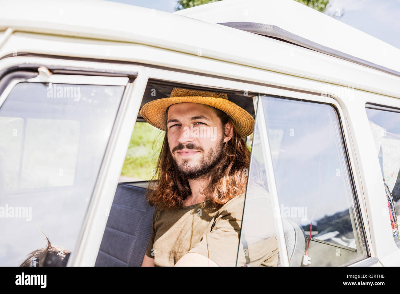 Young man driving camper van hi-res stock photography and images - Alamy