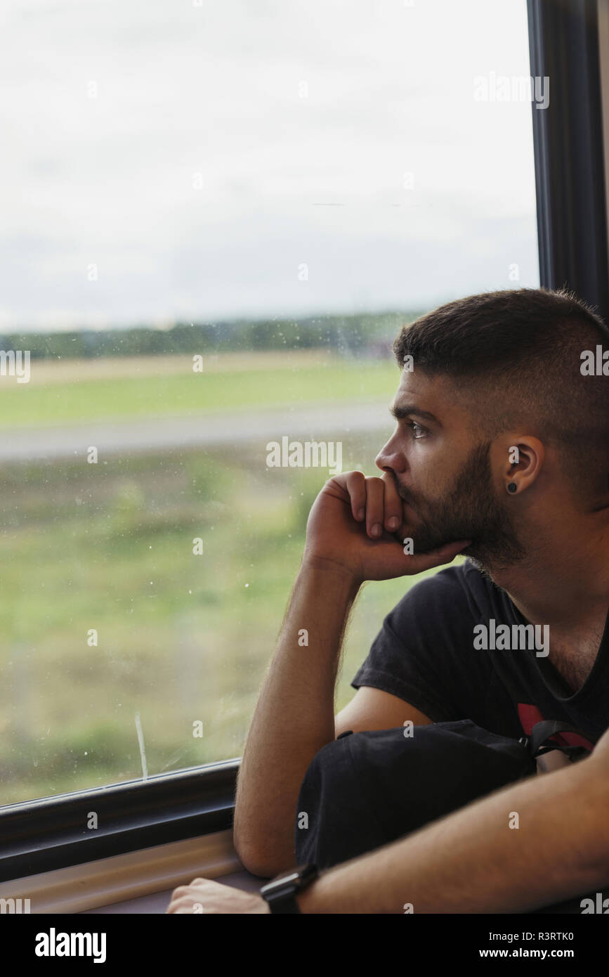 Man looking out of window train hi-res stock photography and images - Alamy