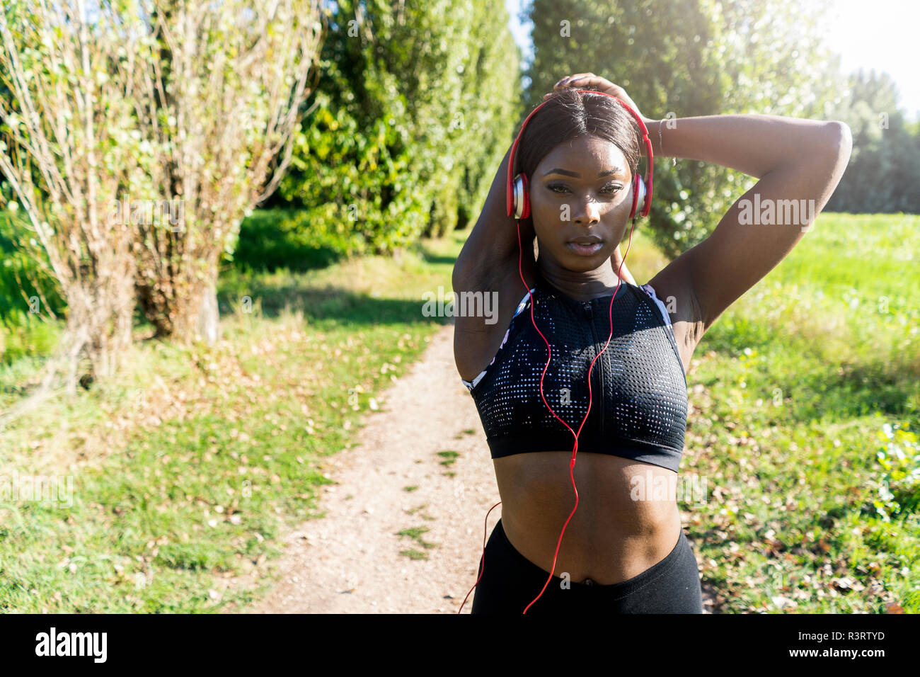 Young athlete stretching in the fields Stock Photo - Alamy