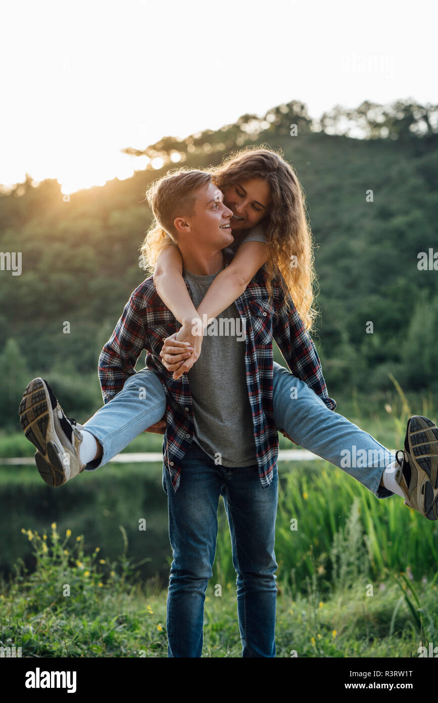 Romantic couple spending time in nature, embracing at sunset Stock ...