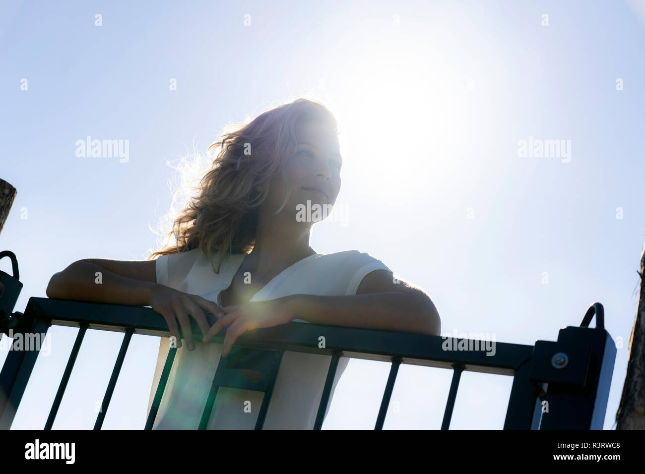Woman leaning on gate hi-res stock photography and images - Alamy