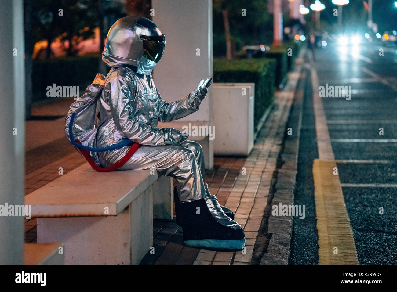 Sitting on bus stop bench hi-res stock photography and images - Alamy