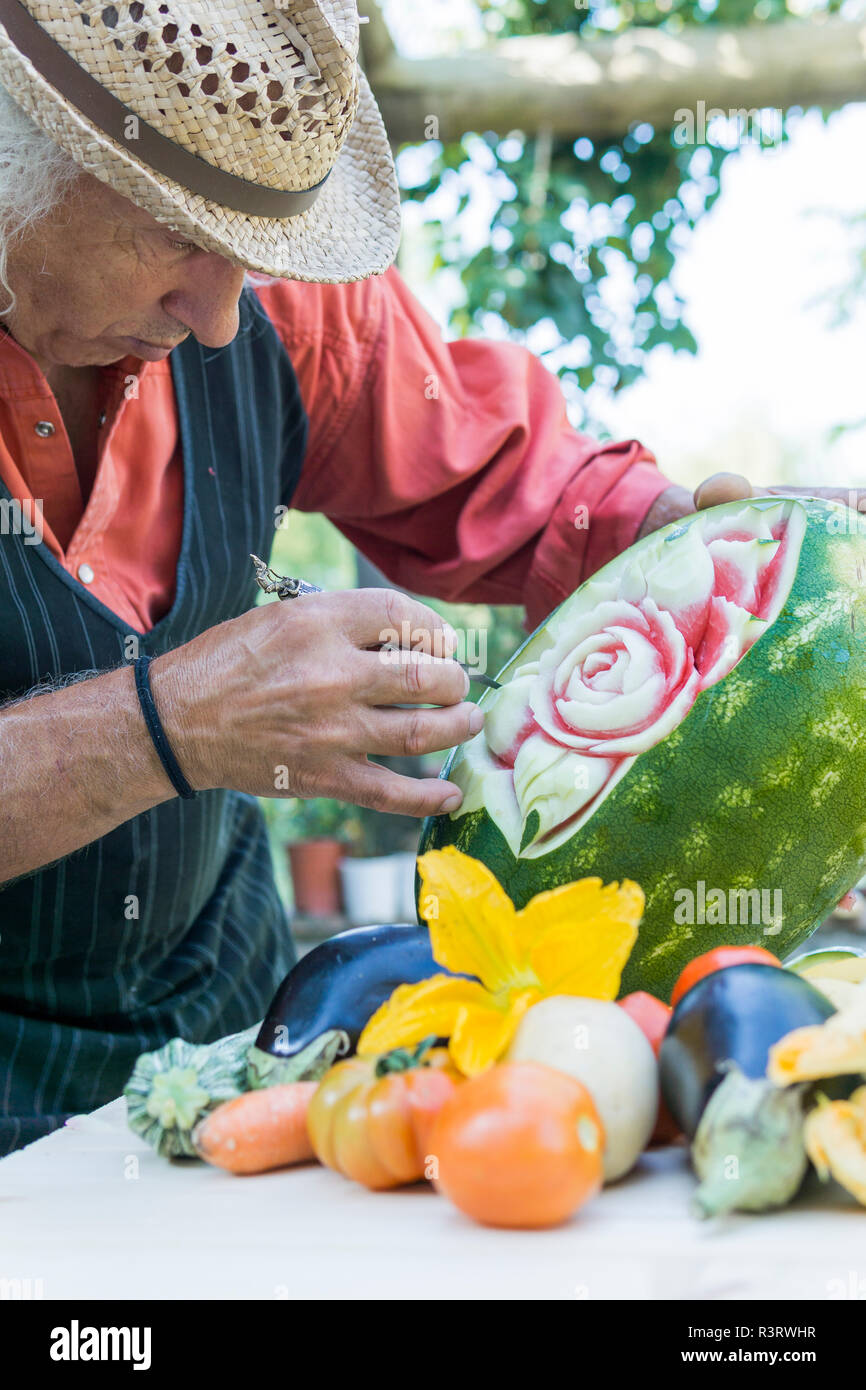 Senior man working watermelon carving tool hi-res stock photography and ...