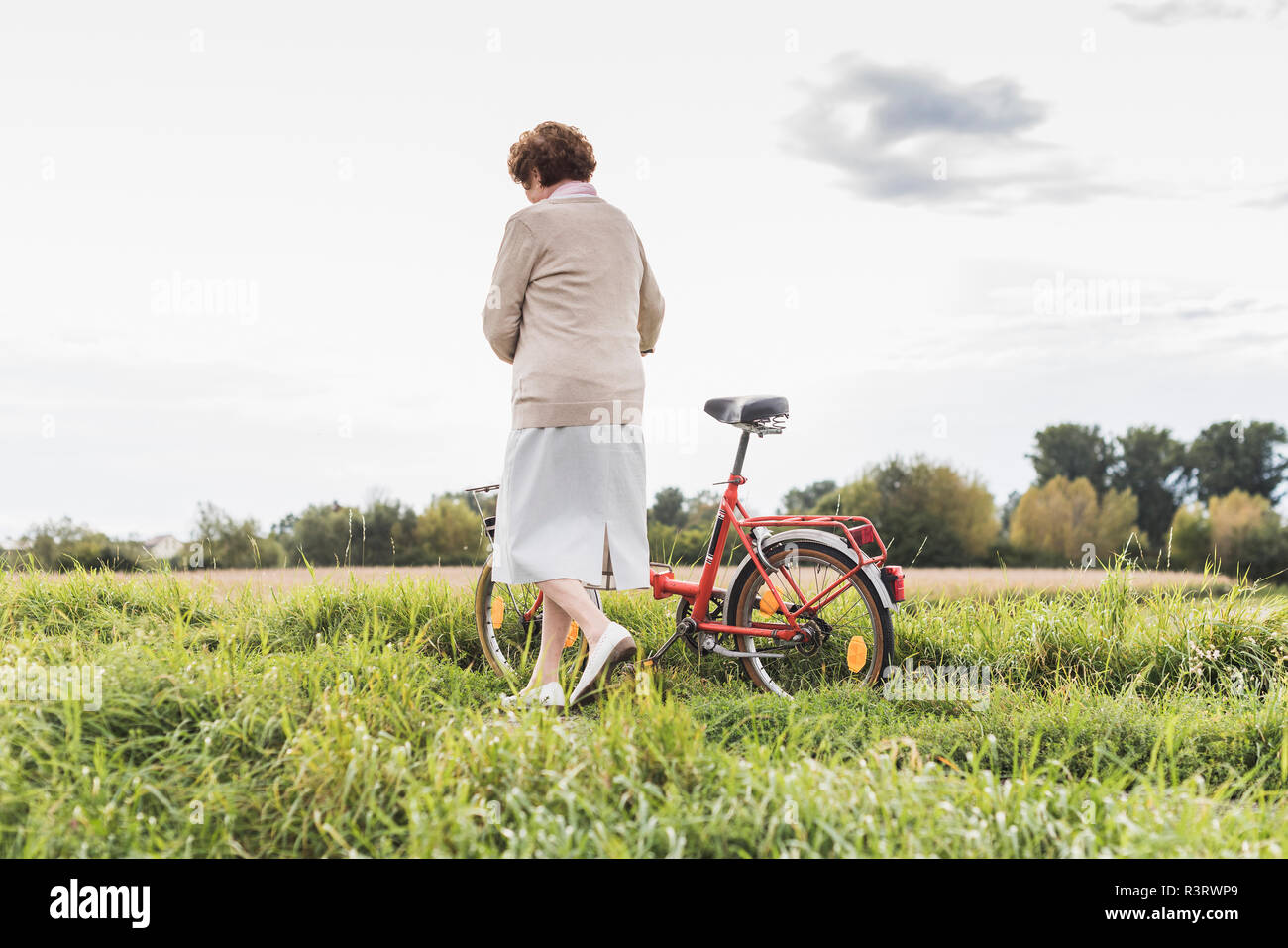 Woman pushing her bicycle hi-res stock photography and images - Alamy