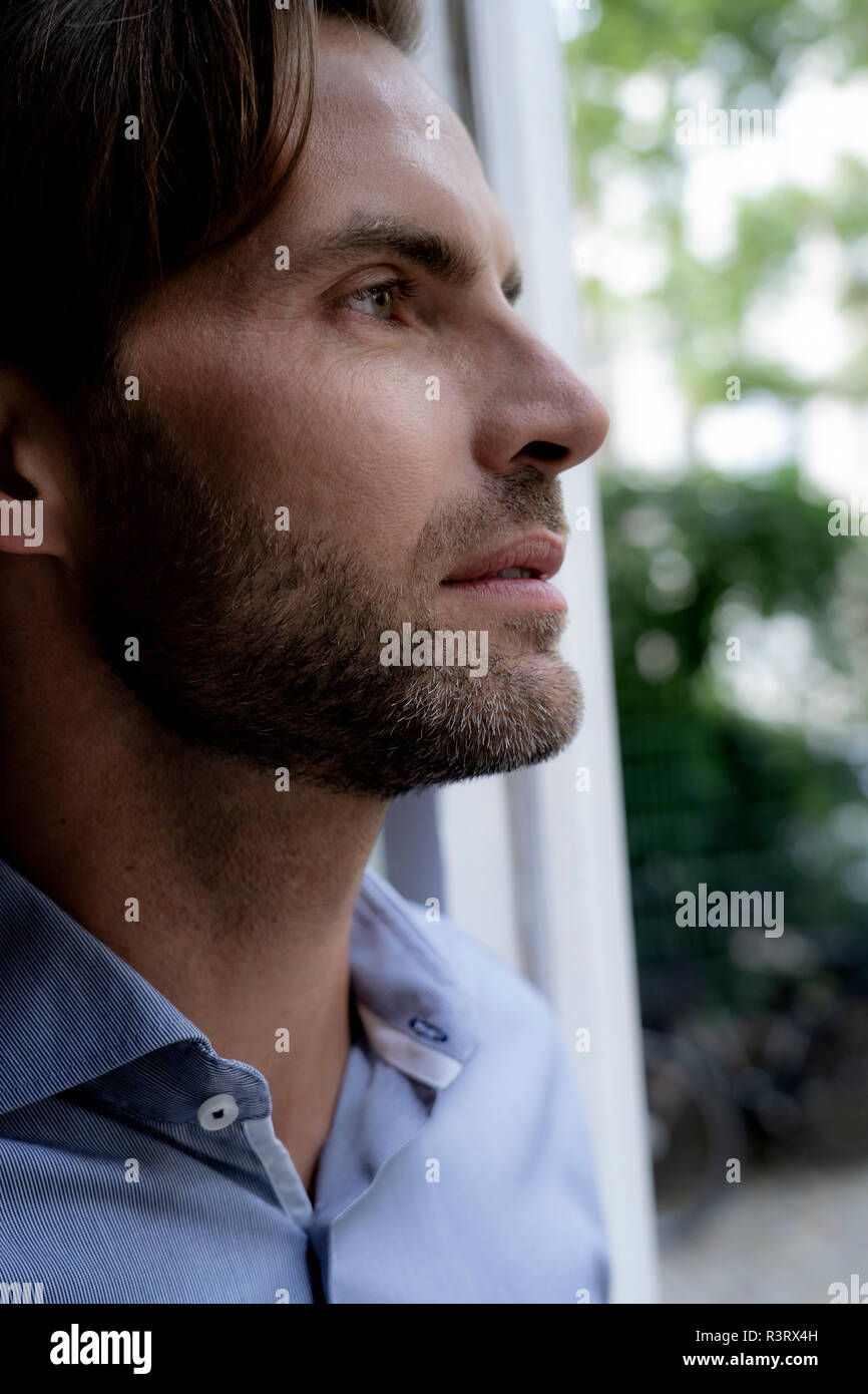 Close-up of man looking out of window Stock Photo - Alamy