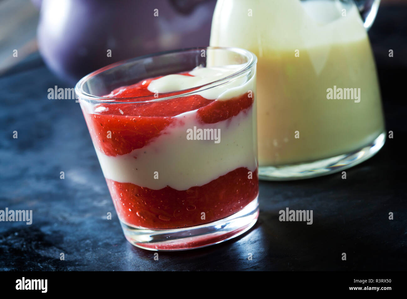 red fruit compote with vanilla sauce layered in a glass Stock Photo - Alamy