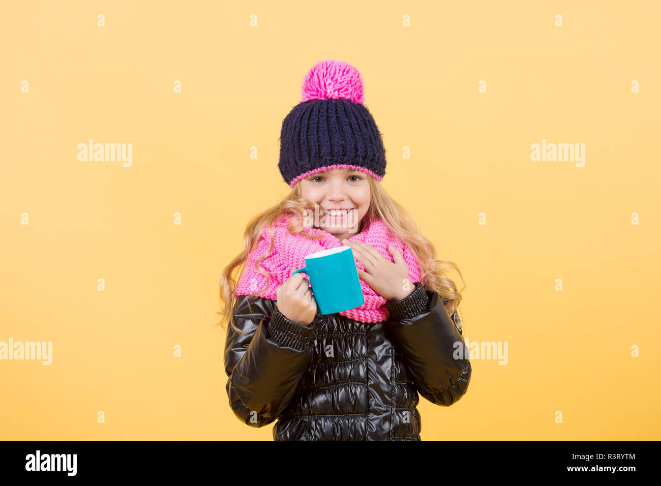 Hot drink in cold weather. Child with blue cup smile on orange ...