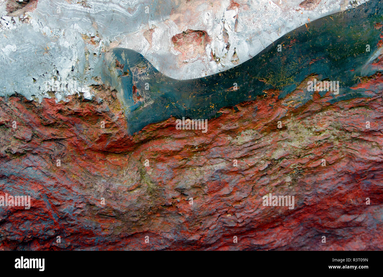Closeup of a red, white and blue rough stone texture background Stock ...