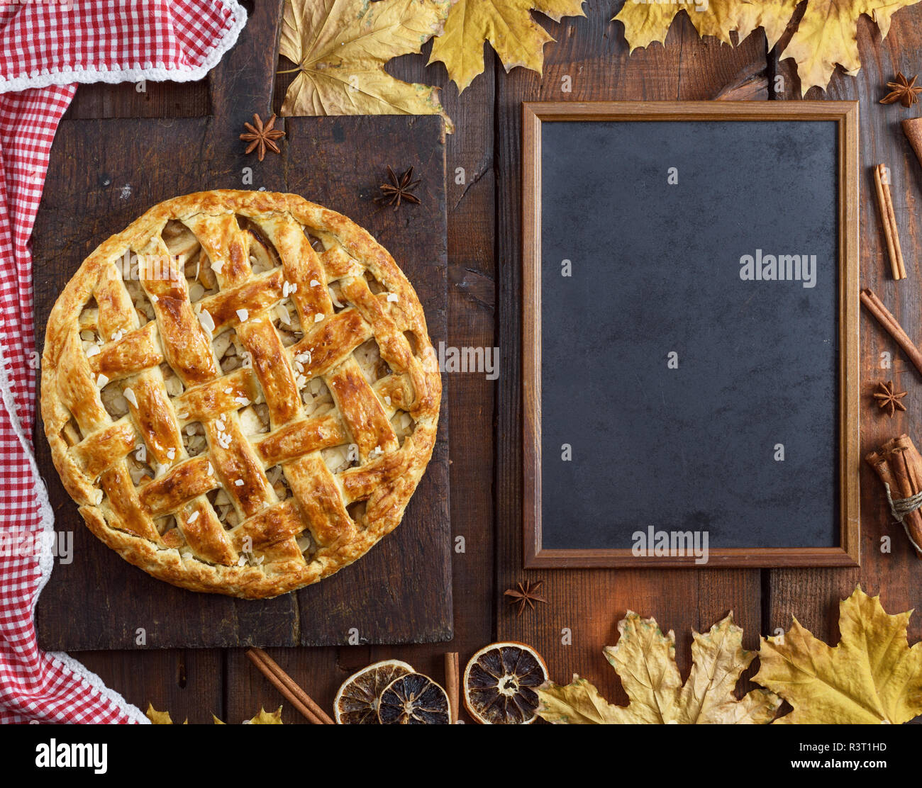empty black chalk board and baked whole fruit cake on brown wooden ...