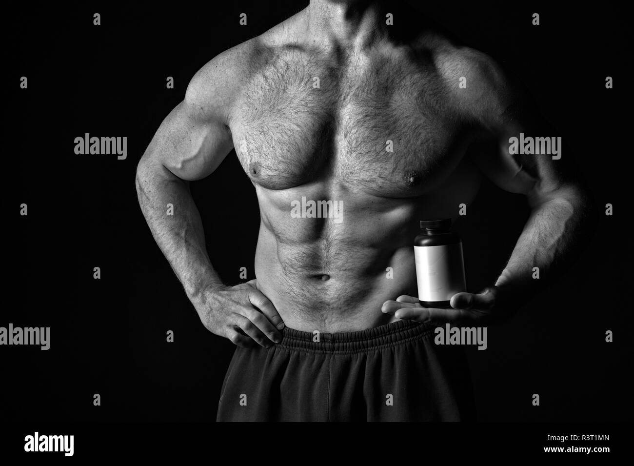 anabolic and drug pill jar, man with muscular body hold vitamin, sport ...
