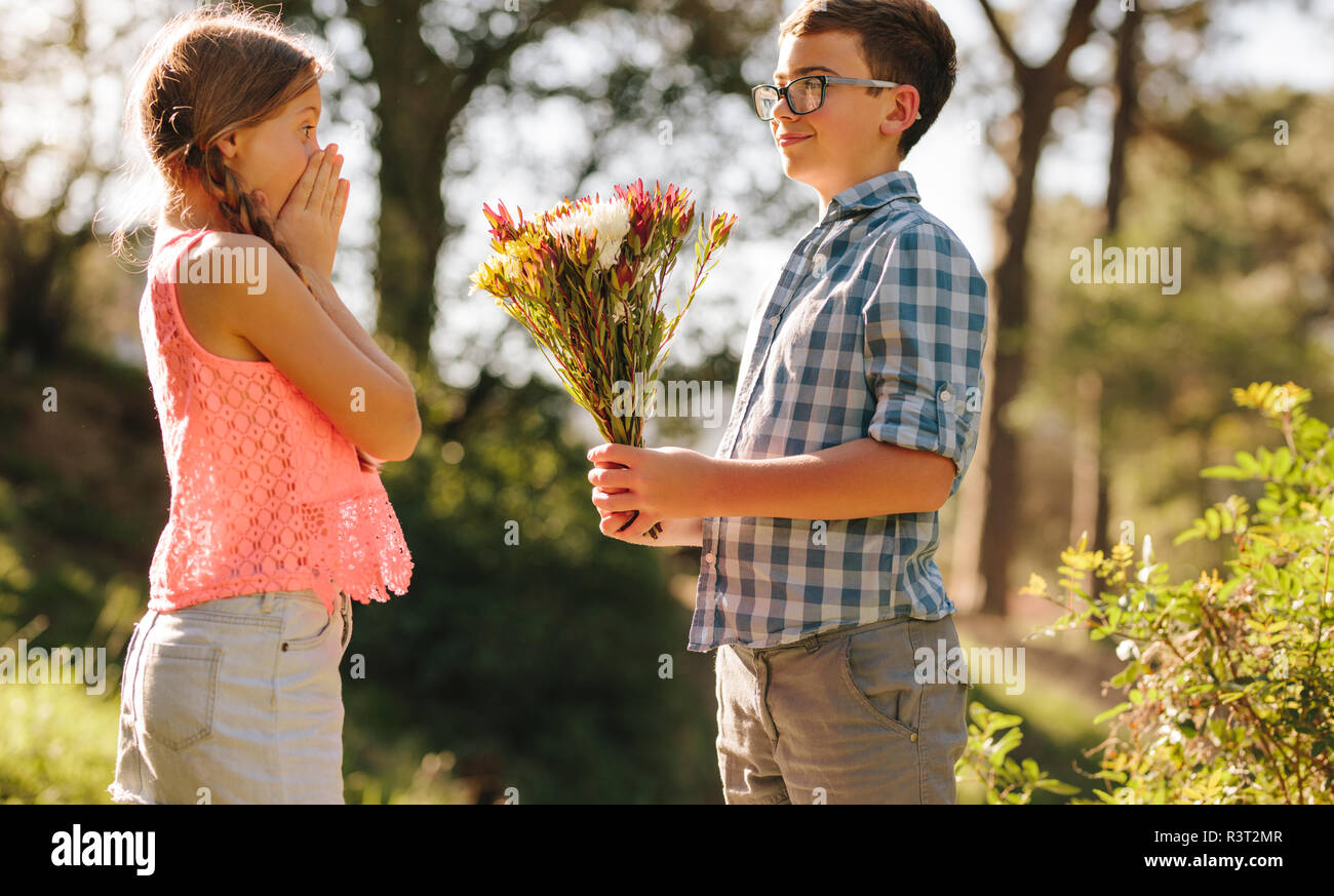 Girl giving boy flowers hi-res stock photography and images - Alamy