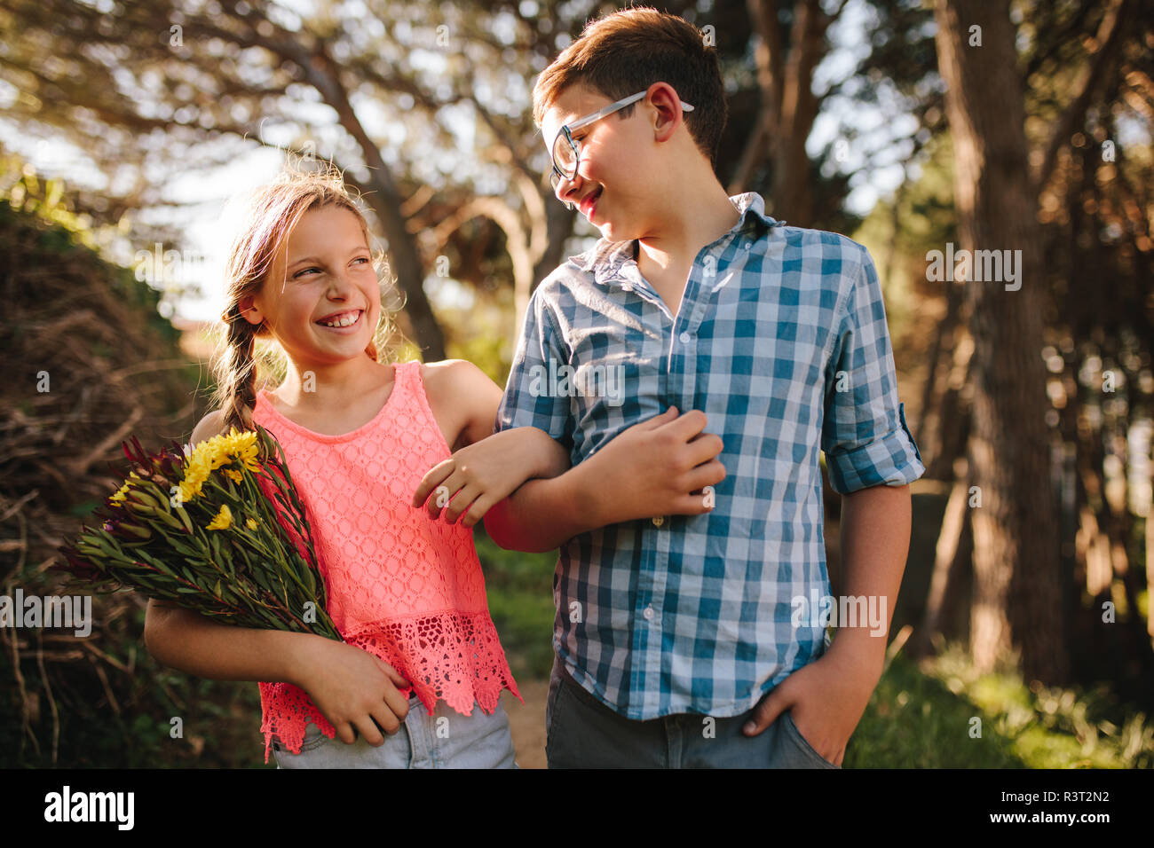 Boy and girl in love walking together in a park holding each other ...