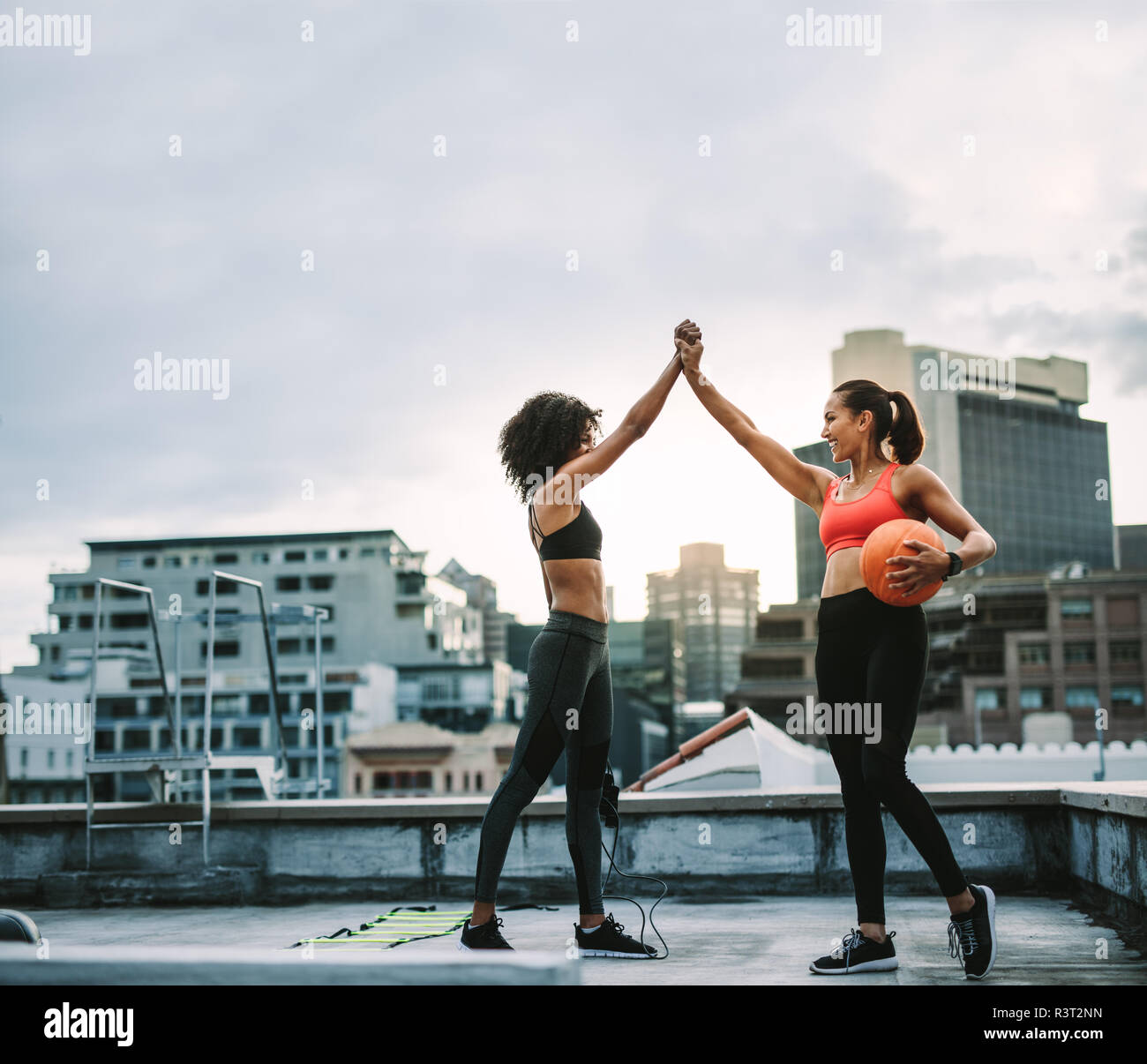 Two young women giving high five hi-res stock photography and images ...