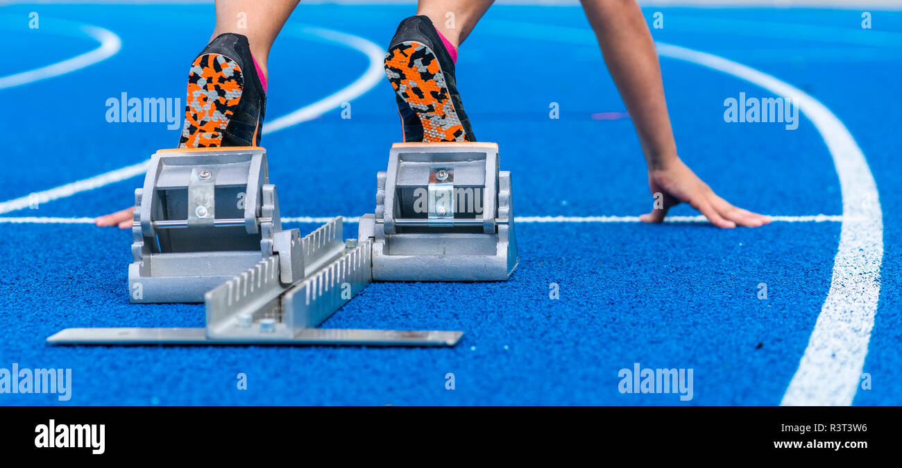 Detail of female runner in starting position Stock Photo - Alamy