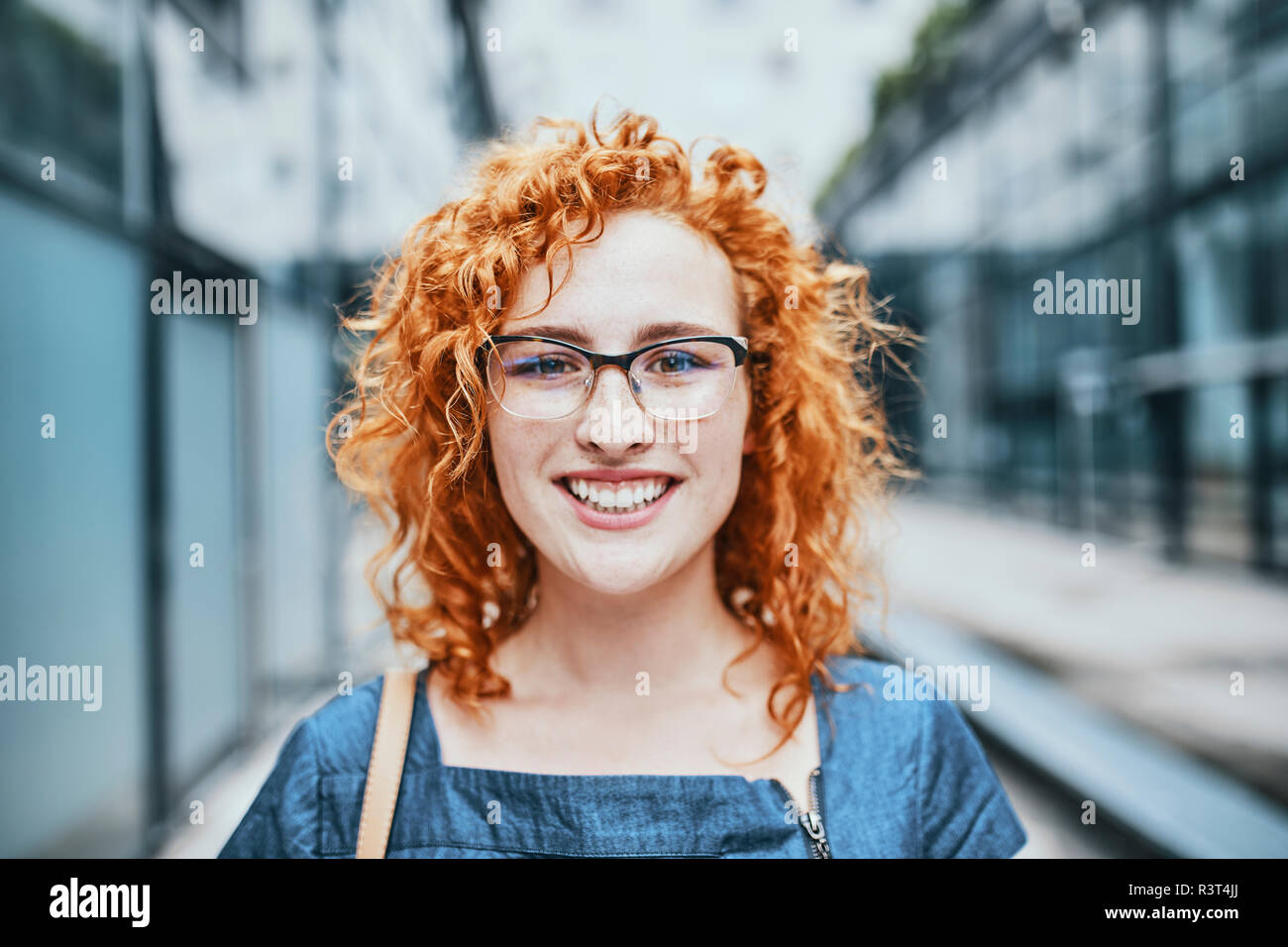Portrait Of A Young Redheaded Woman Wearing Glasses Smiling Stock